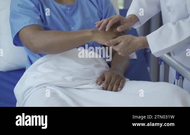 Happy doctor visiting young male patient to bring good news and ...