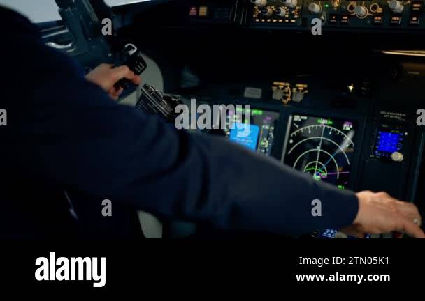 Close-up of a pilot's hand pressing the throttle in the cockpit of jet ...