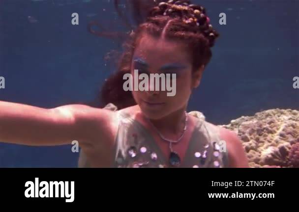 Underwater model free diver swims in clean transparent blue water in ...