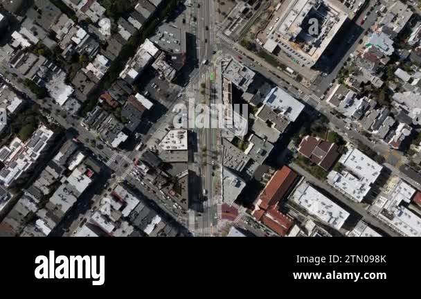 Fly high above city. Top down footage of traffic in streets and ...