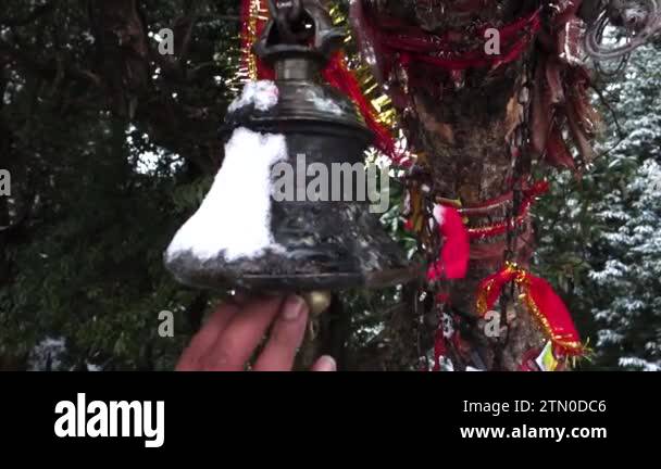 Uttarakhand. India. 23rd Jan 2022. A man ringing bells with holy red ...
