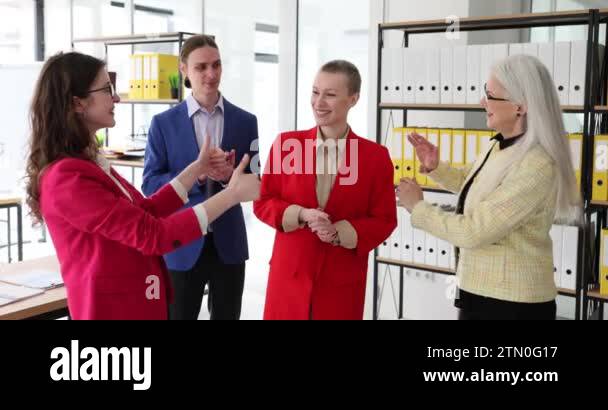 Smiling business people and elderly ceo congratulate colleague on ...