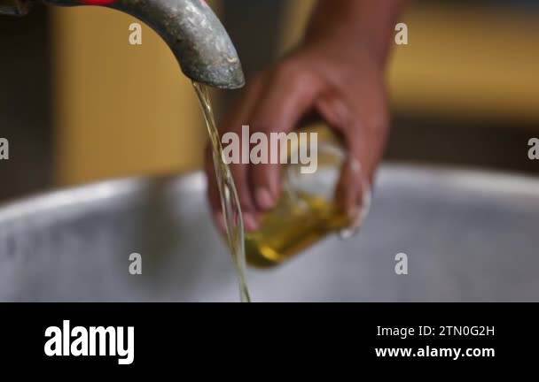 Steel container being filled with an extracted or purified liquid soap ...