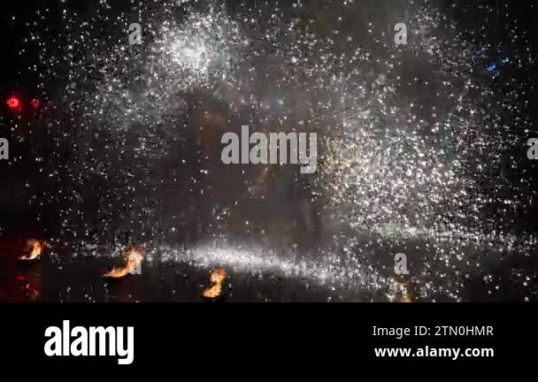 Slow motion unrecognizable fire show artist performing at night using ...