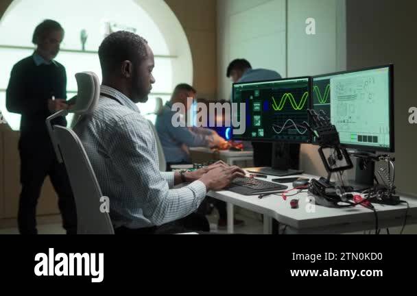 African American engineer using computer while typing on keyboard ...