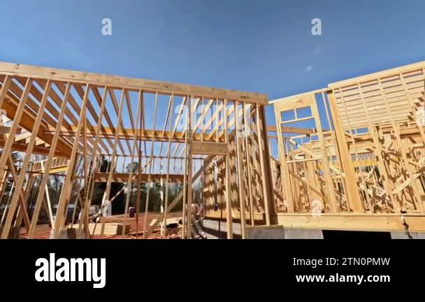 On construction site there are beams of wood stick framing which will ...