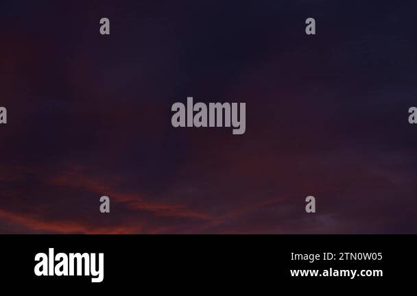 Broken dawn. Crimson clouds, strong red and pink streaks indicate tall clouds reflecting light ...