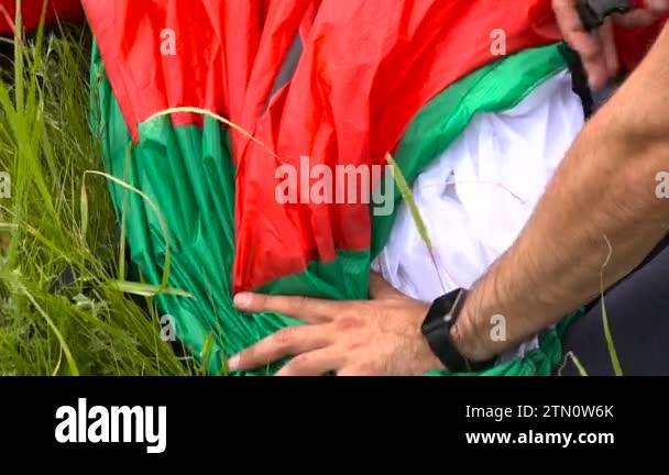 Packing the Paraglider Wing After the End of the Flight. Hands Close-Up ...