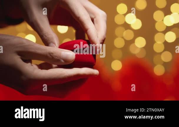 A subtle gesture: his fingers easily hold the box with the wedding ring ...