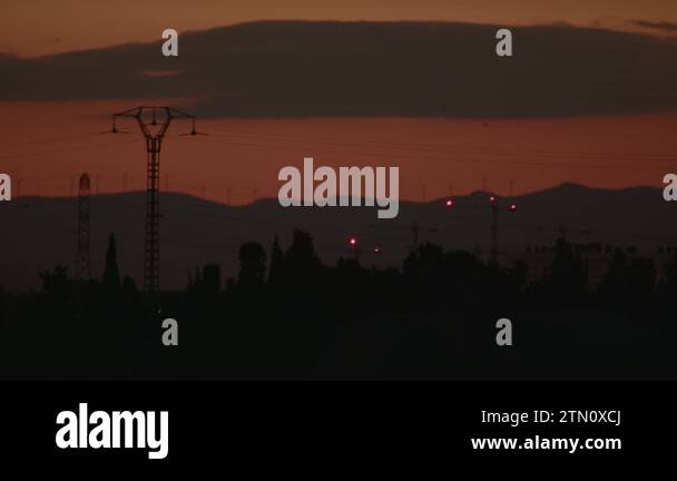Power lines at sunset. Electric poles and high voltage lines against ...
