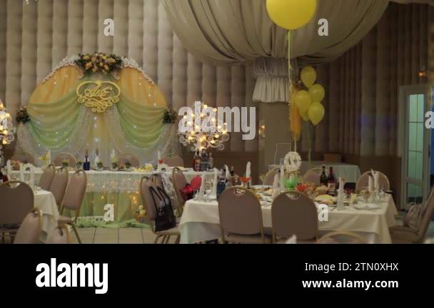 Wedding table at a wedding feast decorated with bridal bouquet. Banquet hall. festive table for ...
