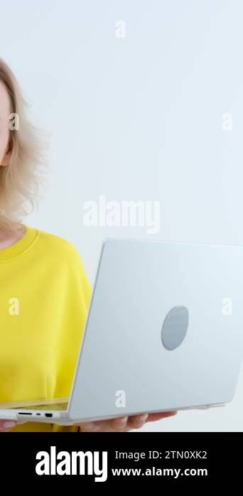 Discontented woman swears at broken or slow computer seated at desk ...