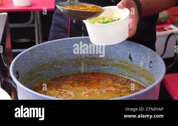 Holding a bowl of laksa. Laksa is a spicy noodle dish popular in ...