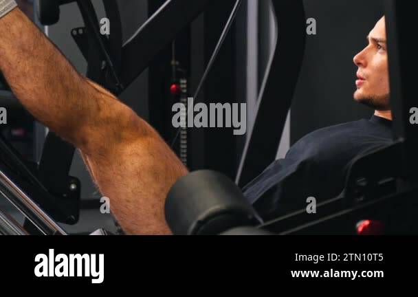 Leg exercise, Physical activity, Well-built coach. Good-looking male ...