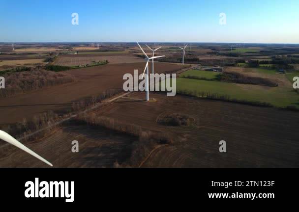 Shot of landscape with wind turbines power station farms on background ...