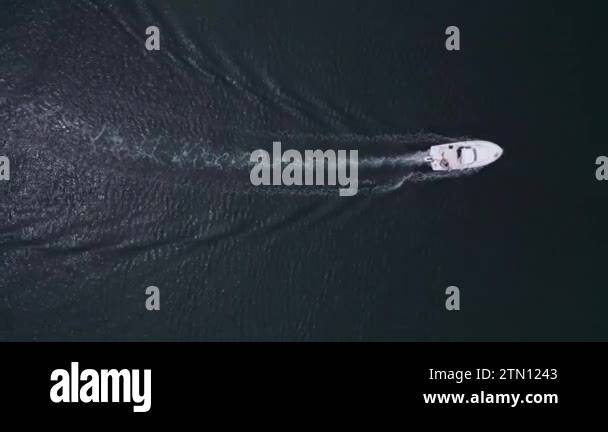Aerial top down view of speed motor boat on open sea at summer day ...