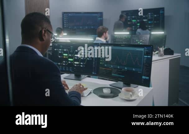 African American big data scientist works at computer with displayed ...