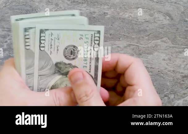 Counting in hands 100 US dollar banknotes of the new model Stock Video ...