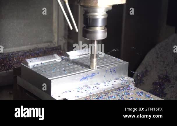 The CNC milling machine rough cutting the injection mold insert part by ...