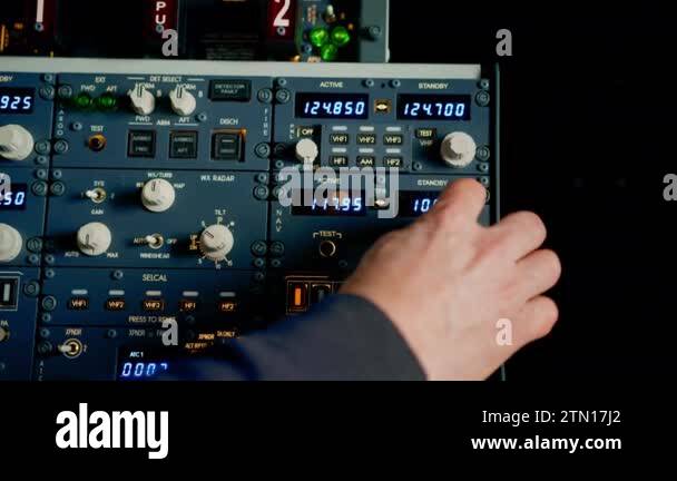 The captain presses the buttons on the control panel to start the ...