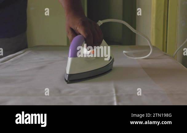 Man ironing clothes on an ironing board.hand with iron housework.male ...