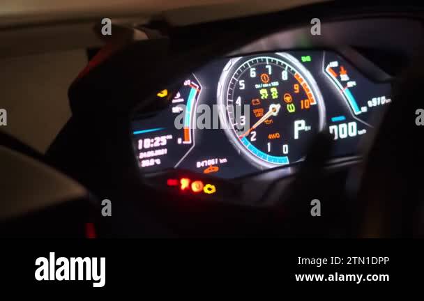Illuminated control panel of an expensive premium sports car driving at ...