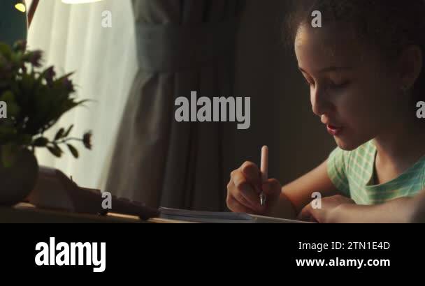 Cute smart primary school child girl learning writing doing math ...