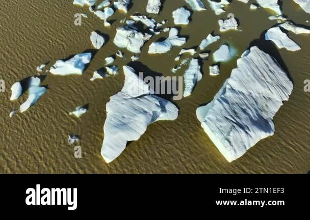Large Chunks of Ice Float in Brown Glacier Lagoon in Iceland Global ...