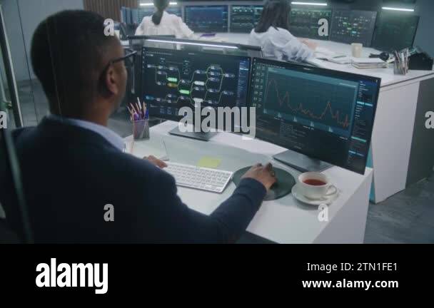 African American big data scientist works at computer with displayed ...