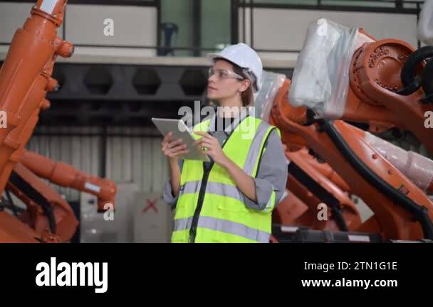 Maintenance engineer worker working with robotic machine automation at factory, Female ...