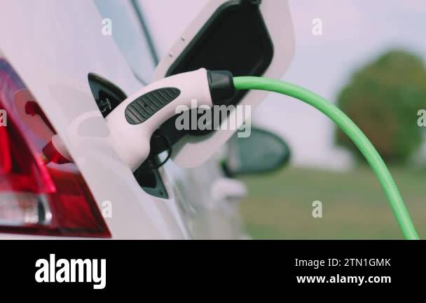 Electric vehicle Recharging battery charging port plugging in EV modern ...
