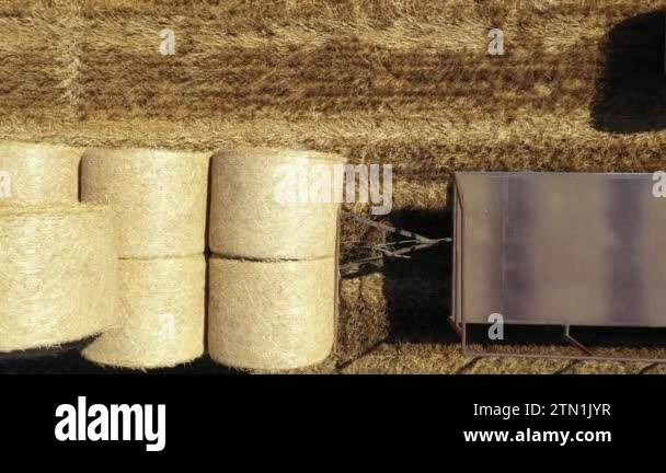 Above top view, dolly move upwards over excavator as loading straw ...