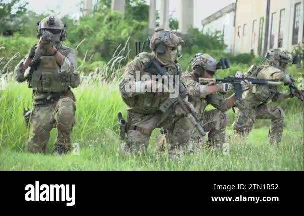 Smart teamwork of soldiers walking forward and attacking enemy during military operation, Army ...
