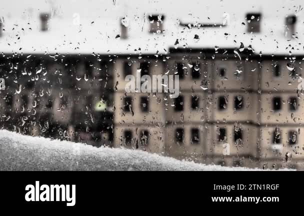 View from the window to the winter thaw. Melting snowdrift and drops on ...