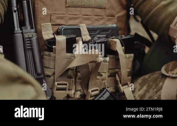 A soldier in a military uniform with a magazine of cartridges for a ...