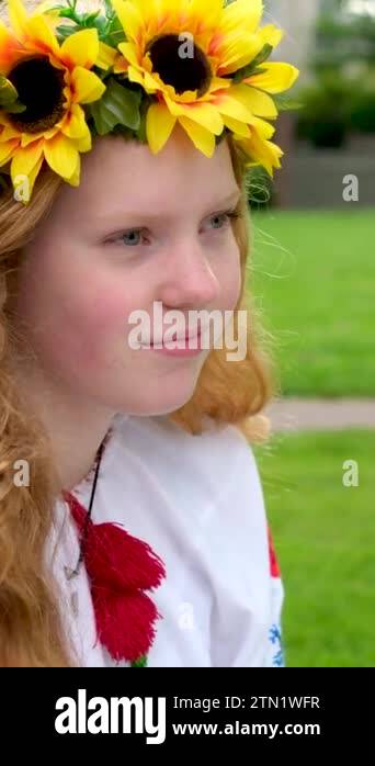 Cute Ukrainian girl with long braid, in traditional embroidered clothes ...