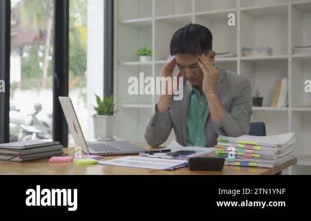 Asian business man Sitting working on laptop with office syndrome ...