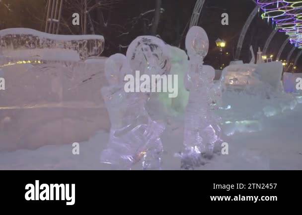 Icy sculpture of frozen dancing people in winter city. Ice Sculptures ...
