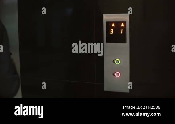 Woman press the button in the elevator and wait. Female standing in ...