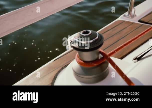 Close-up view of capstan head shining in the sun. Rope fixing around ...