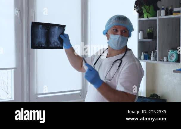 Calculus 8 mm in the ureter on x-ray in the doctor's hands. Doctor ...