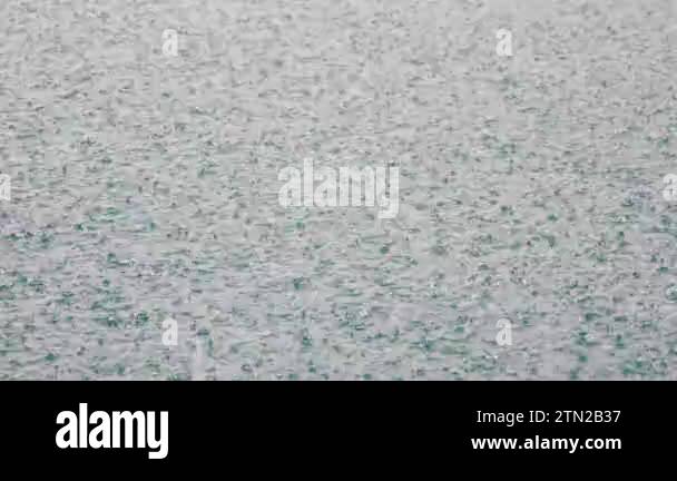 Heavy rain pounds the lake surface. Rainstorm with strong winds. Rain ...