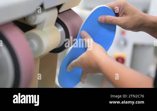 Prosthetic technician sculpting plaster cast for socket at prosthetic production factory, High ...