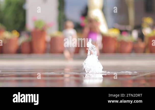 Pedestrian fountain close-up. Dry fountain in summer, water splashes ...