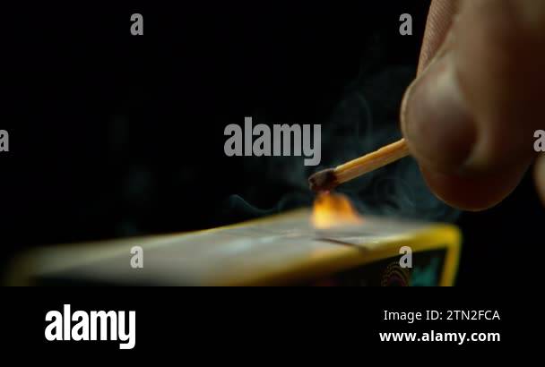 Match, orange flame glow and hand with matchbox stroke with sparks ...