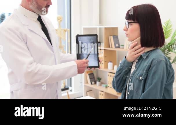 Female brunette talking about discomfort under C collar while male ...