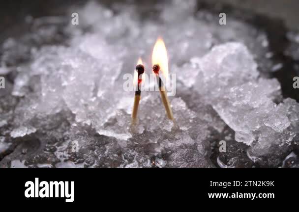 Two Matches are Burning in a Flame of Fire on Wet Snow. Burning charred ...