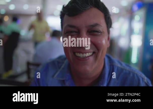One happy Brazilian young man close-up face laughing and smiling inside ...