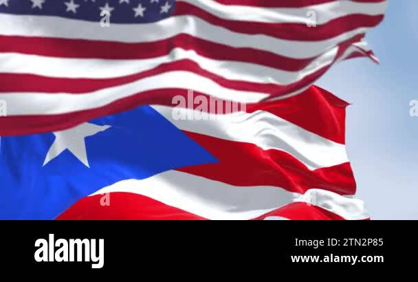 Puerto Rico flag waving with the United States flag on a clear day ...