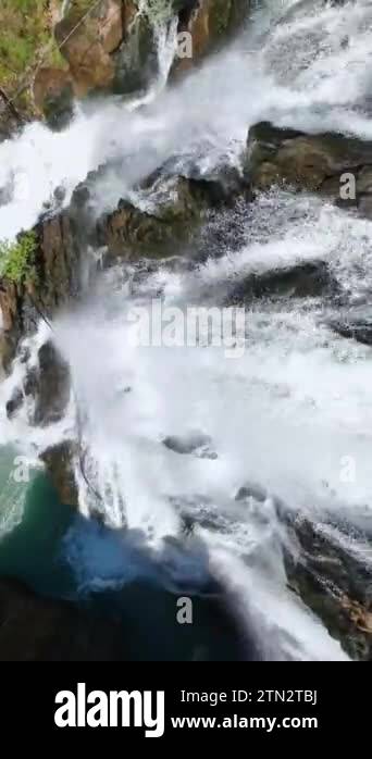 Marvel at the splendor of azure cascades as the drone captures the ...